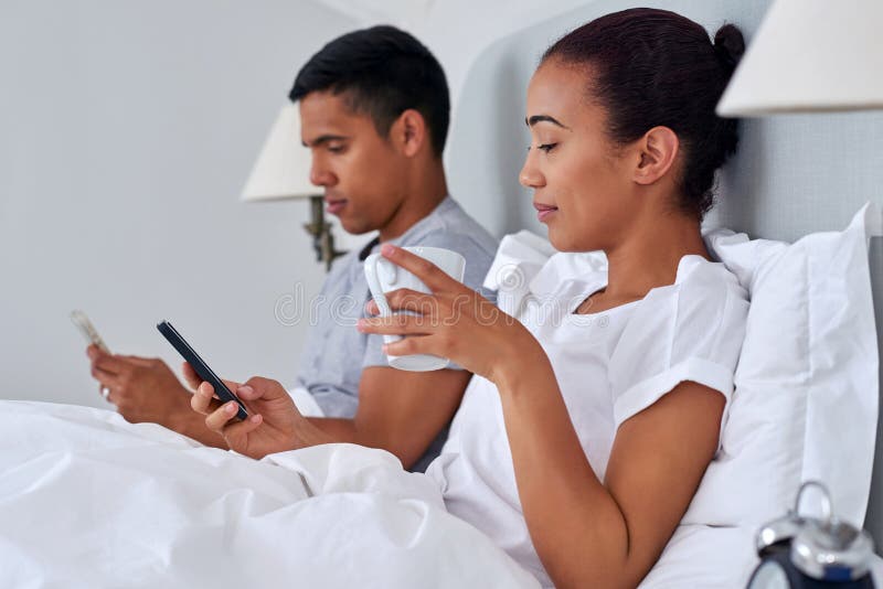 Couple cellphone bed stock photo. Image of email, concentrating - 53265318