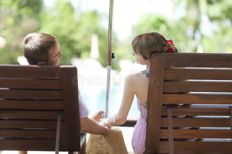 Couple in chaise longues stock image. Image of girlfriend - 22496691