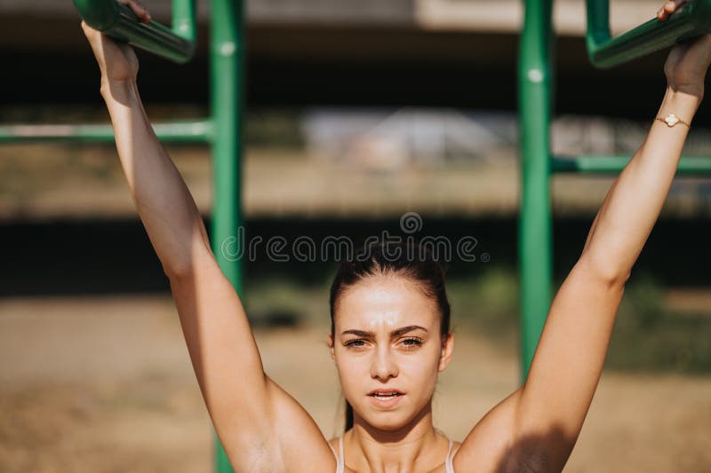 A Couple Challenges Themselves Outdoors, Doing Pull-ups on Metal Bars ...