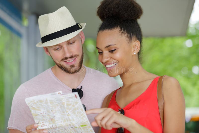 Couple Checking Directions To Where To Go Stock Photo - Image of back ...