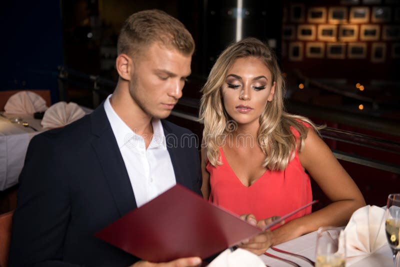Couple Choosing from Menu in Restaurant Stock Image - Image of ...