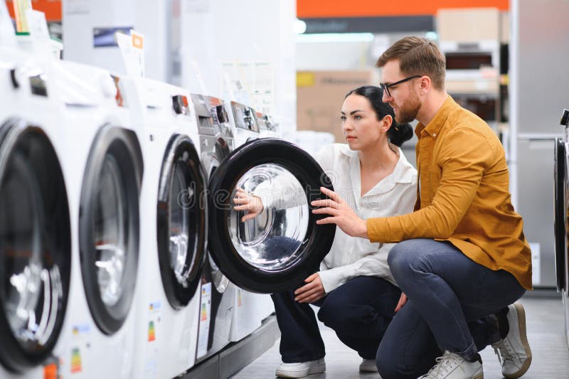 Couple Choosing Wasing Machine at Electronics Store Stock Photo - Image ...