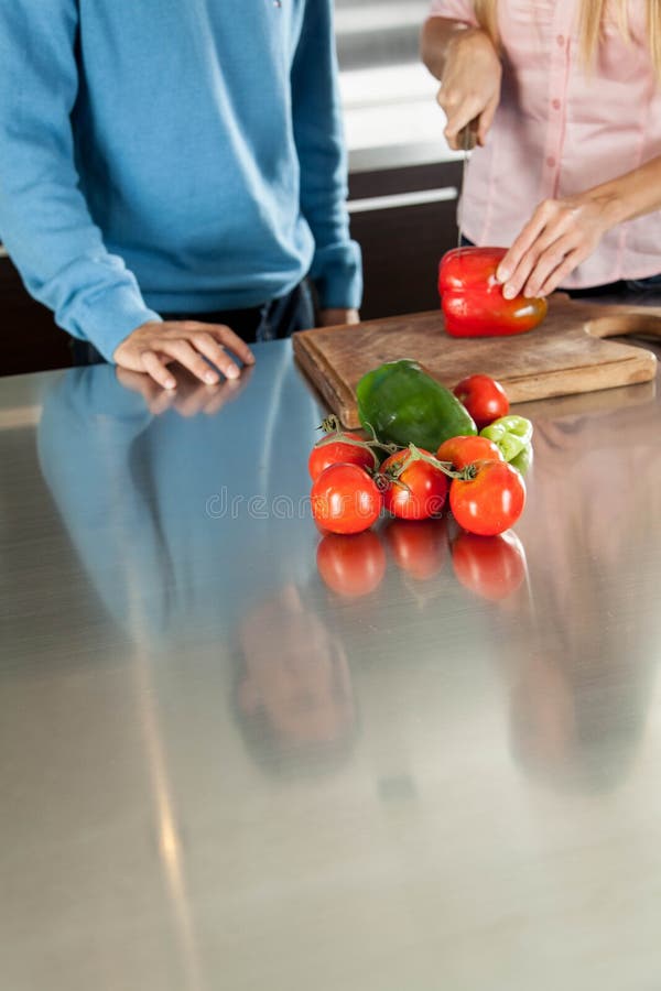 Couple chopping vegetables stock image. Image of dinner - 73875995