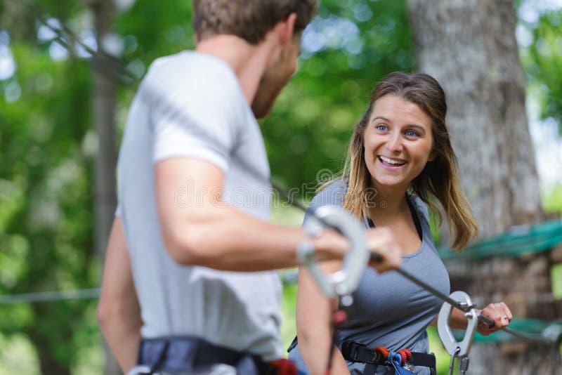 Couple climbing on rope stock photo. Image of strength - 200683556