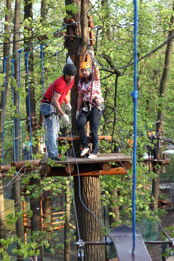 Couple climbing the rope stock photo. Image of clambering - 54083462