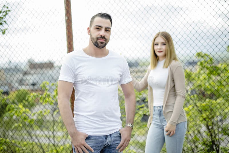 Couple Close To a Fence in a Day Stock Photo - Image of city, romantic ...