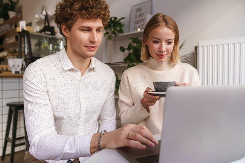 Couple Colleagues Sit in Cafe Indoors Using Laptop Computer Stock Image ...
