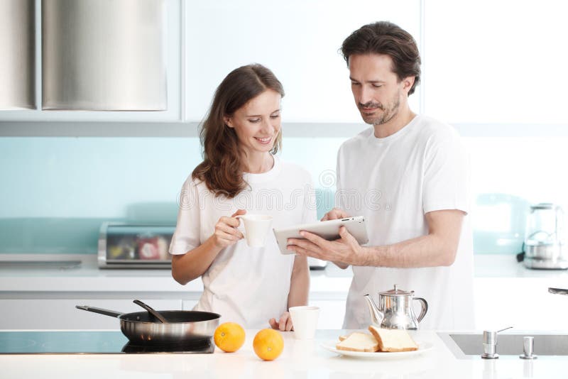 Couple cooking breakfast stock image. Image of love, recipe - 75792431