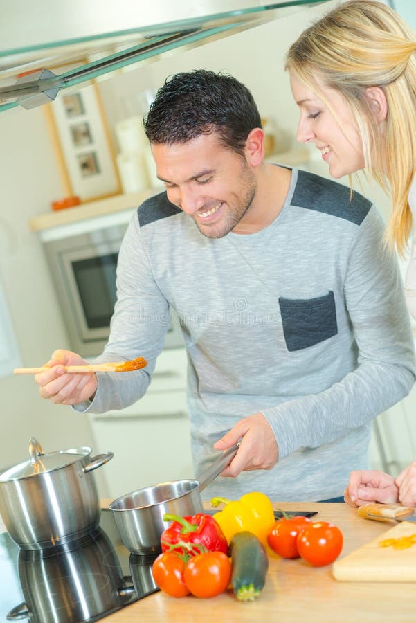 Couple cooking together stock image. Image of smile - 281500591