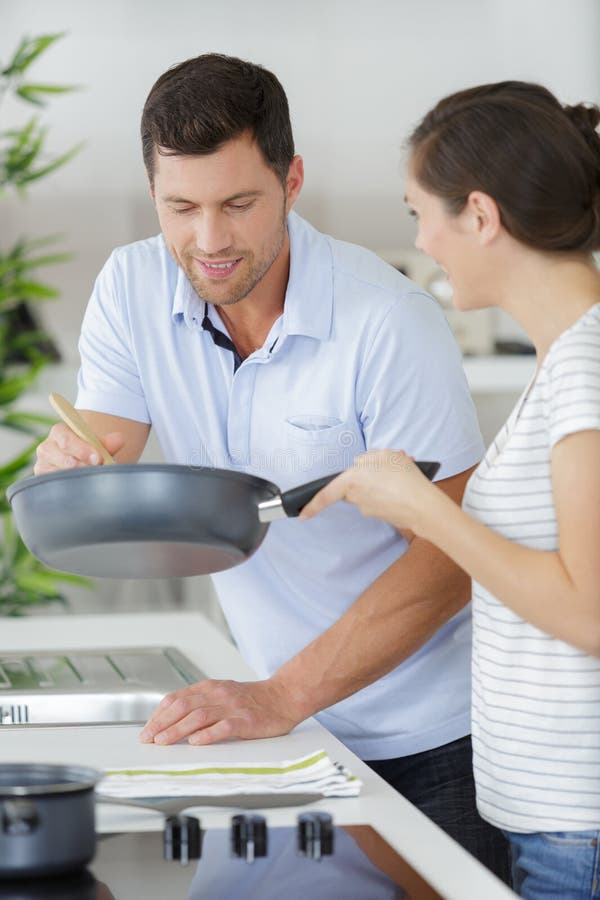Couple cooking together stock photo. Image of cook, cooking - 288844318