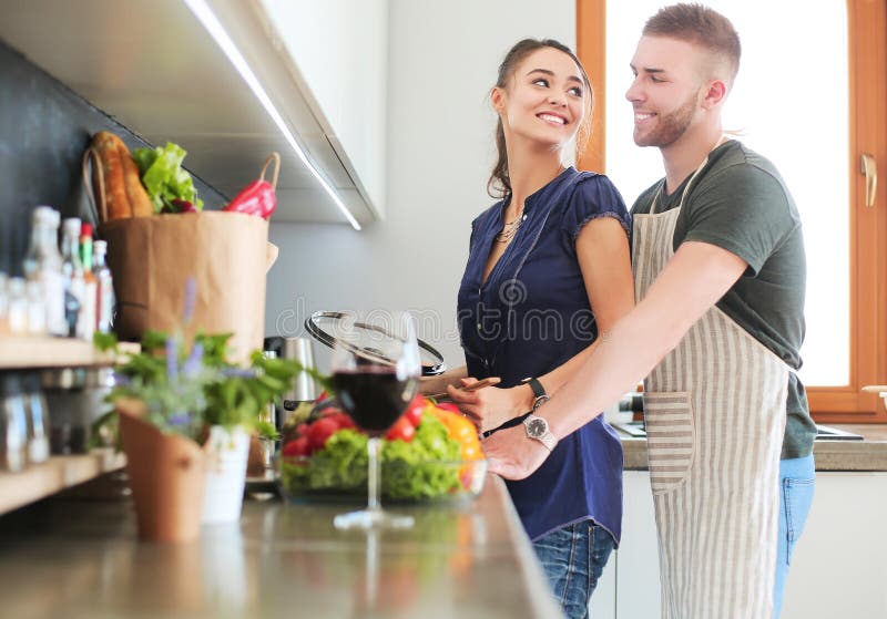 Couple Cooking Together in Their Kitchen at Home Stock Image - Image of ...
