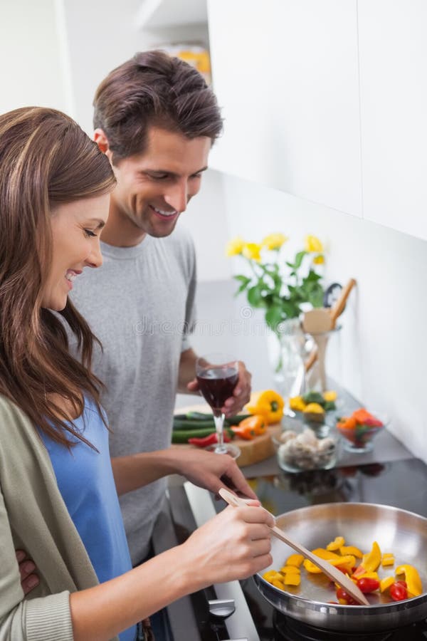 Young Couple Cooking in Kitchen Together Stock Image - Image of couple ...