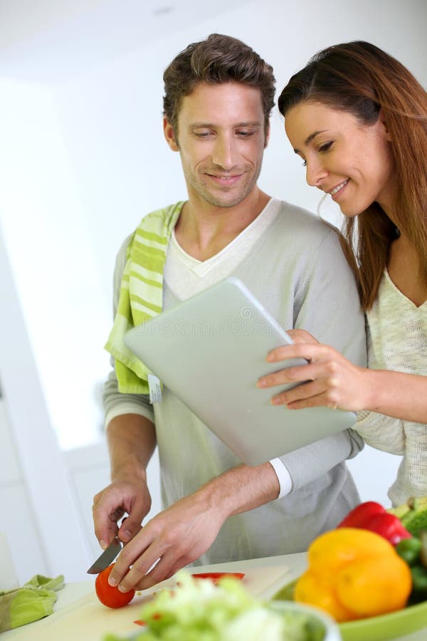 Couple Cooking and Using Tablet Stock Photo - Image of cook, looking ...