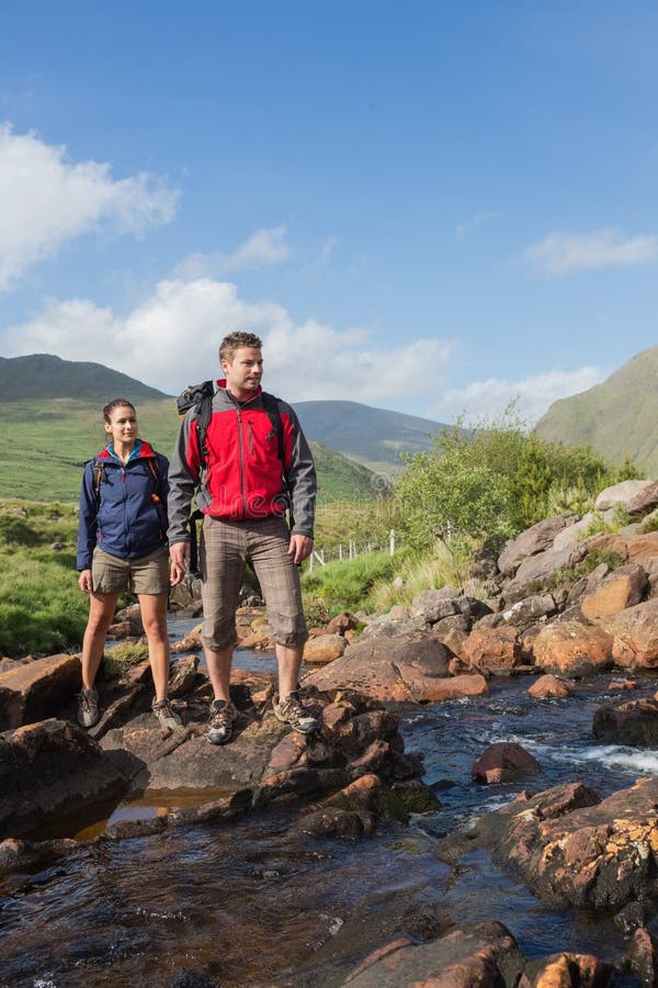 Couple Crossing a Stream Together Stock Image - Image of adventuring ...