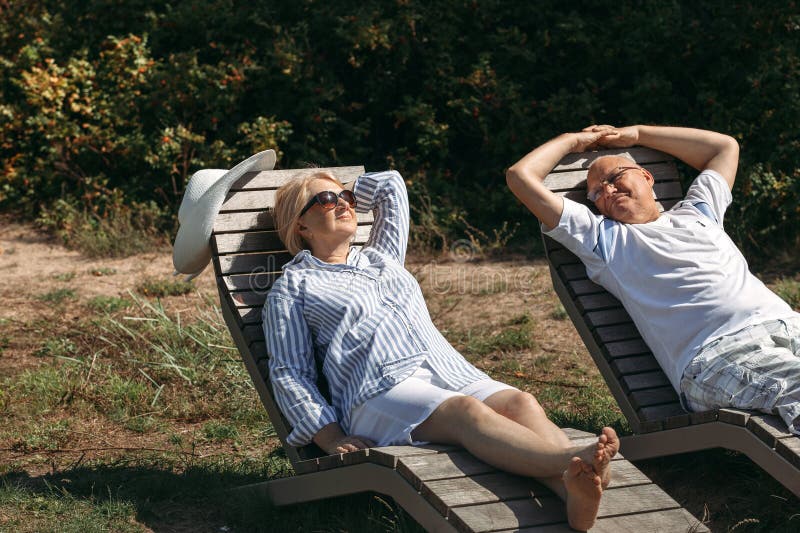 A Couple of Cute Elderly People are Lying on Sunbeds, Basking in the ...