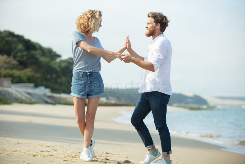 Couple dancing on beach stock image. Image of together - 200683879