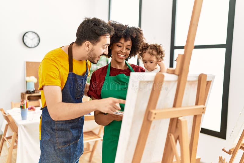 Couple and Daughter Smiling Confident Drawing at Art Studio Stock Photo ...