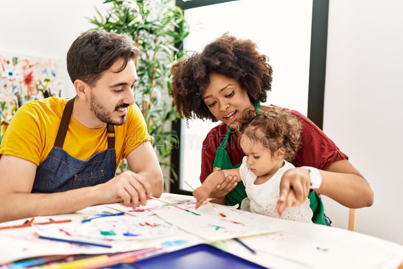 Couple and Daughter Smiling Confident Drawing at Art Studio Stock Photo ...