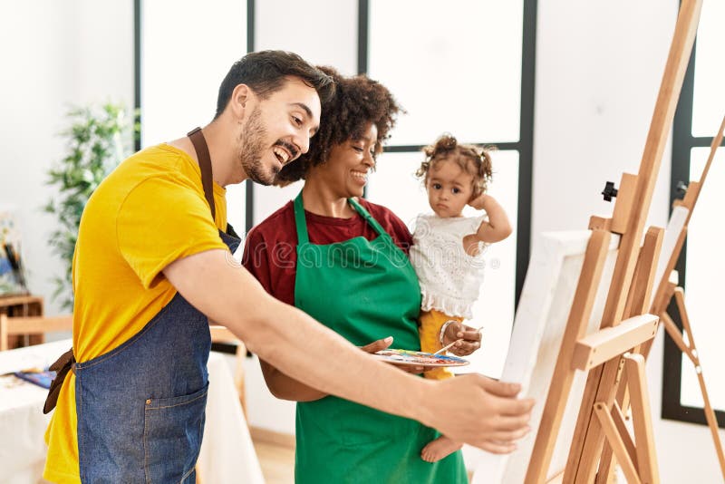 Couple and Daughter Smiling Confident Drawing at Art Studio Stock Photo ...