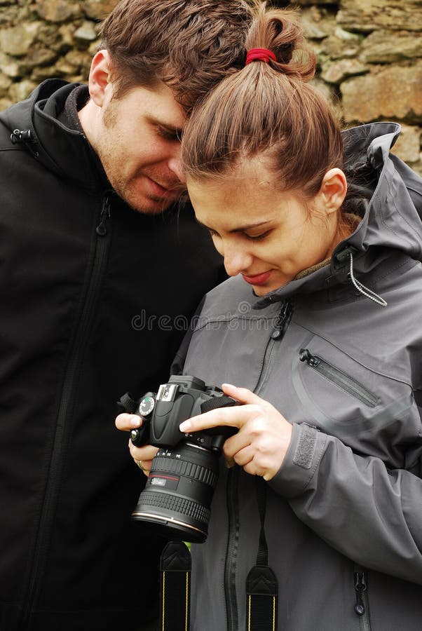 Couple with digital camera stock image. Image of woman - 19204535