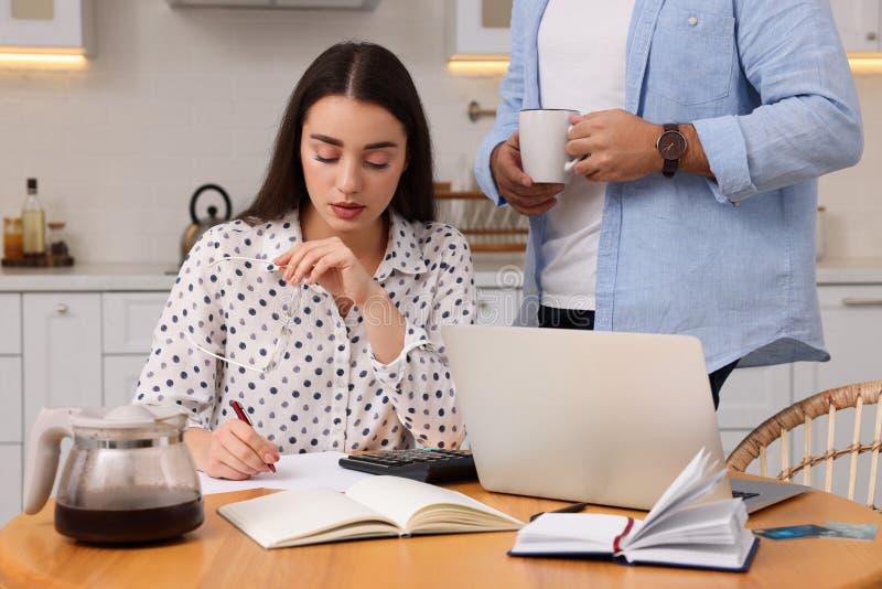 Young Couple Discussing Family Budget in Kitchen Stock Image - Image of ...
