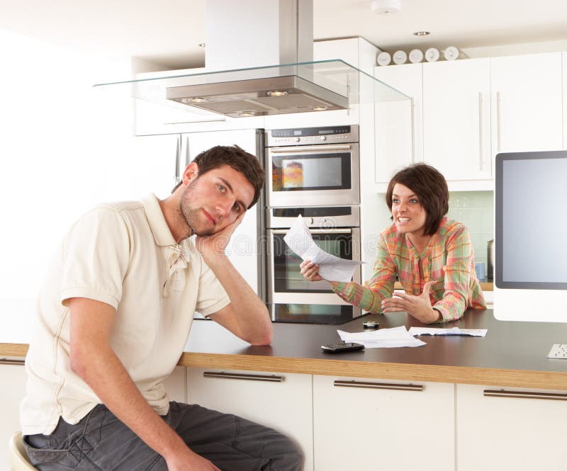 Couple Discussing Personal Finances in Kitchen Stock Photo - Image of ...