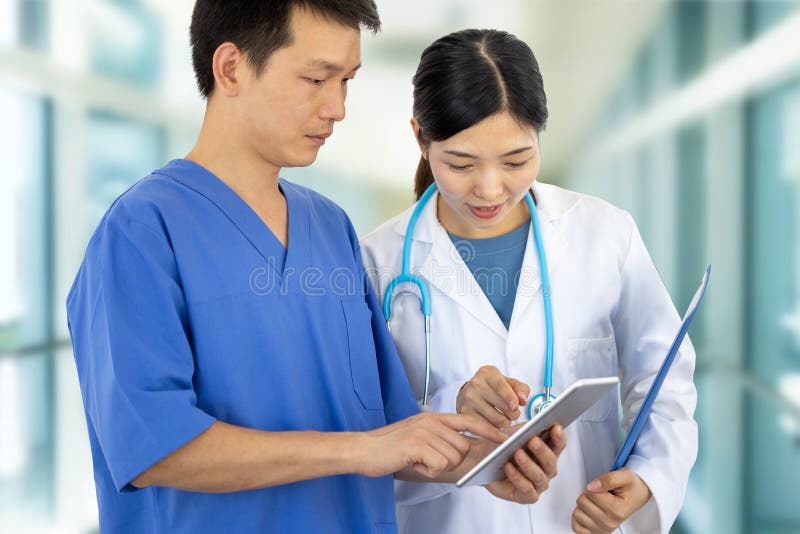 Couple of Doctors at Work with Lab Coats, Stethoscopy and Tablet Stock ...
