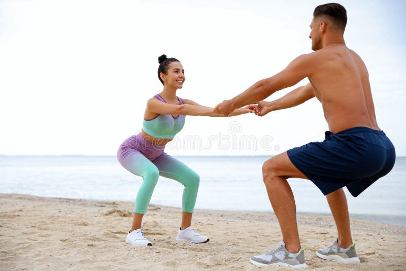 Couple Doing Exercise Together on Beach. Body Training Stock Image ...