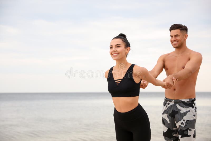 Couple Doing Exercise Together on Beach, Space for Text. Body Training ...