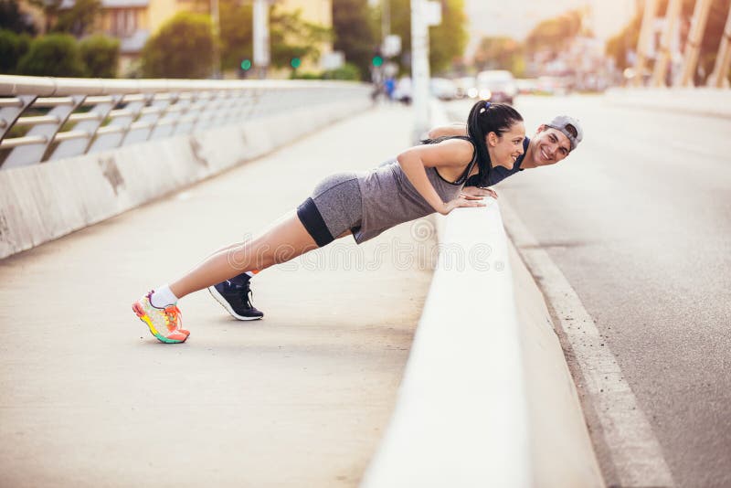 Couple Doing Push-ups Outdoors on the Bridge Stock Image - Image of ...