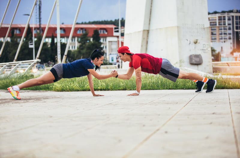 Couple Doing Push-ups Outdoors on the Bridge Stock Image - Image of ...