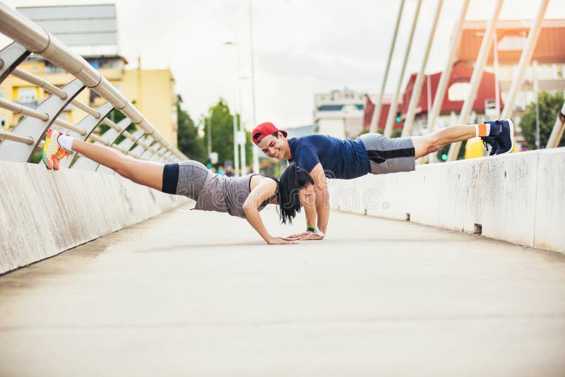 Couple Doing Push-ups Outdoors on the Bridge Stock Photo - Image of ...