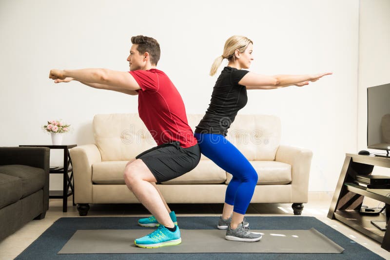 Couple Doing Some Squats Together Stock Photo - Image of couch, latin ...