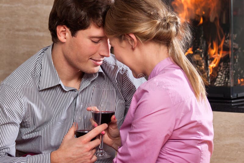 Couple drinking by fire stock photo. Image of relation - 36082456