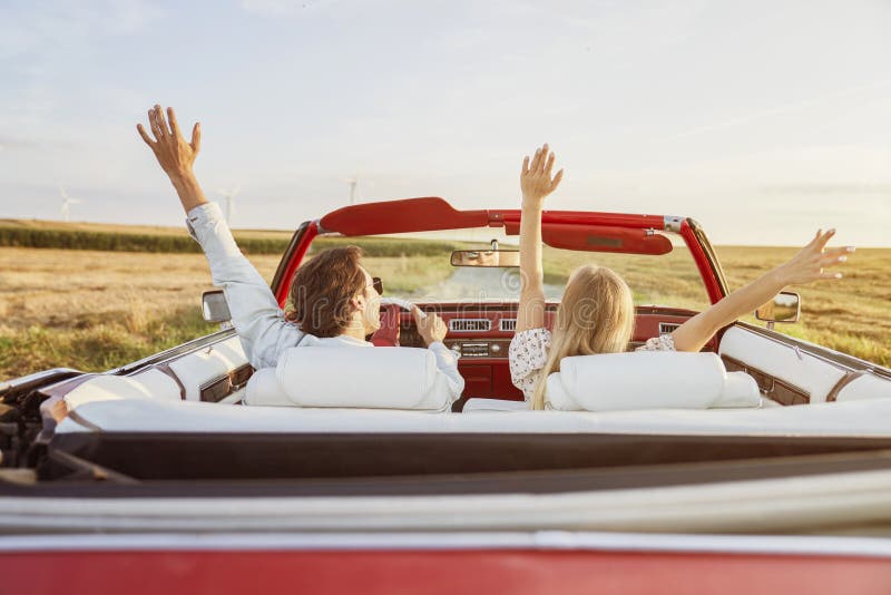 Rear View of Couple Driving in Convertible Under Sunny Sky Stock Photo ...