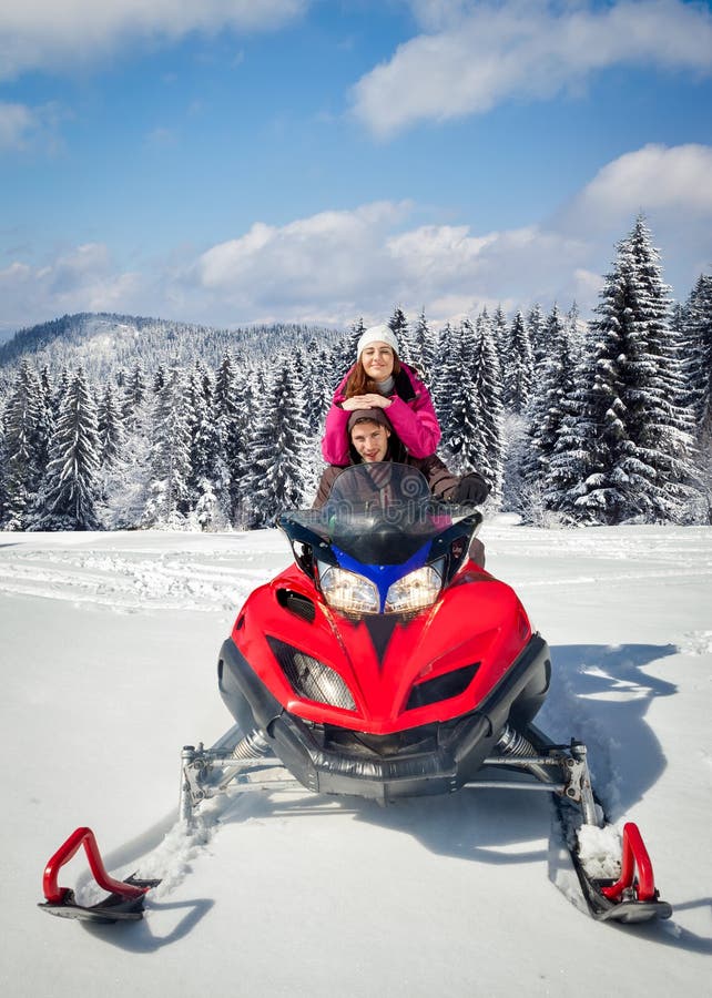 Couple driving snowmobile stock photo. Image of leisure - 35287082