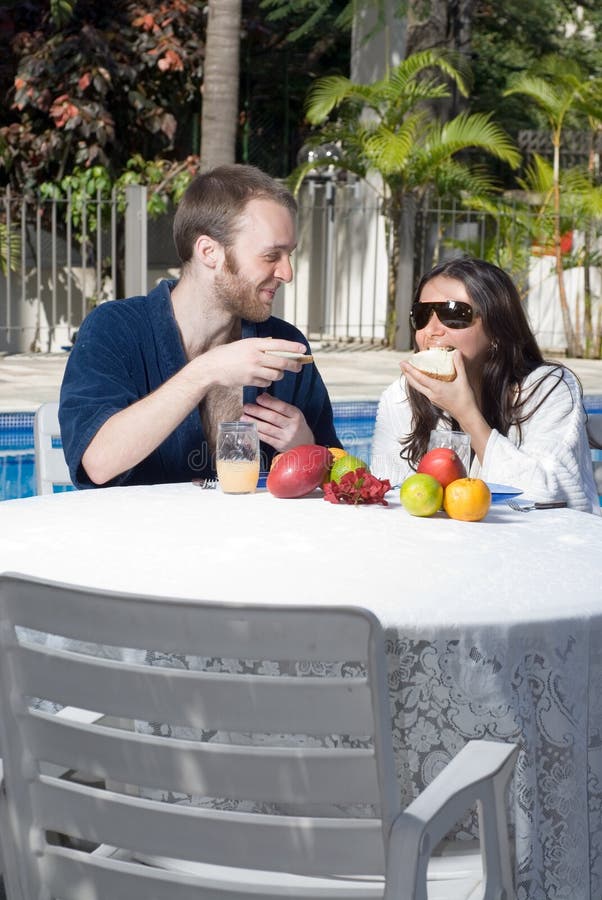 Couple Eat by Pool - Vertical Stock Photo - Image of ethnicity, outside ...