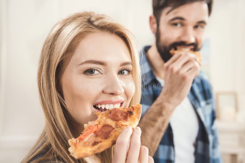 Couple Eating Delicious Pizza Stock Image - Image of table, food: 93032861