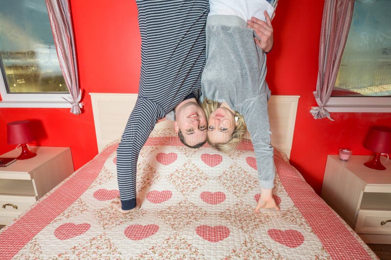 Couple in an Embrace Stand Upside Down on the Bed Stock Photo - Image ...
