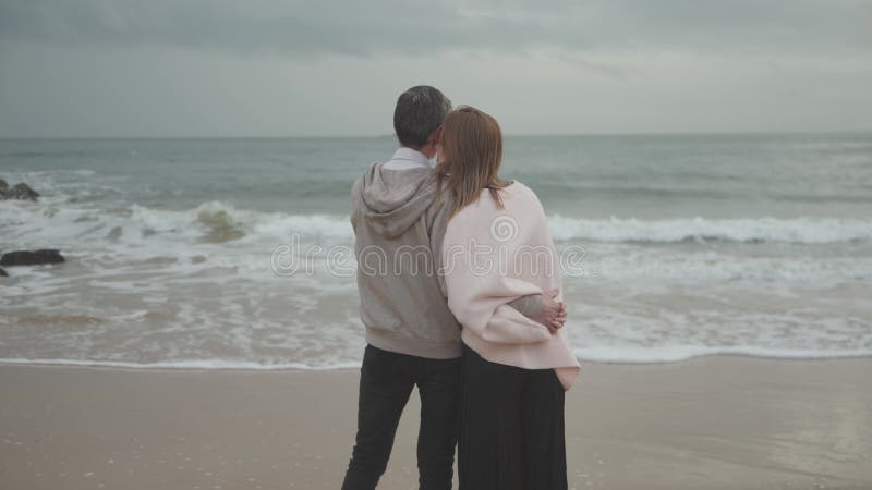 Romantic Couple Embracing on Beach, Watching Ocean Waves Stock Video ...
