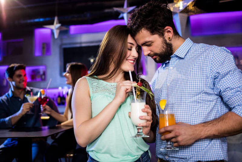Couple Embracing Each Other at Bar Counter while Having Cocktail Stock ...