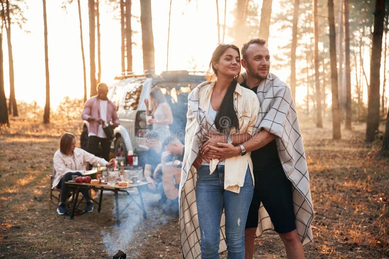 Couple is Embracing Each Other. Group of Friends are Together in the ...