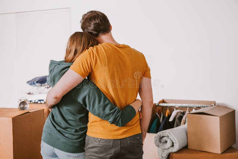 Couple Embracing while Facing Moving Boxes Stock Photo - Image of ...