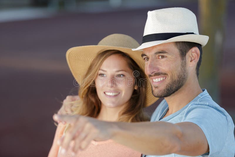 Couple Embracing Man Pointing into Distance Stock Image - Image of ...