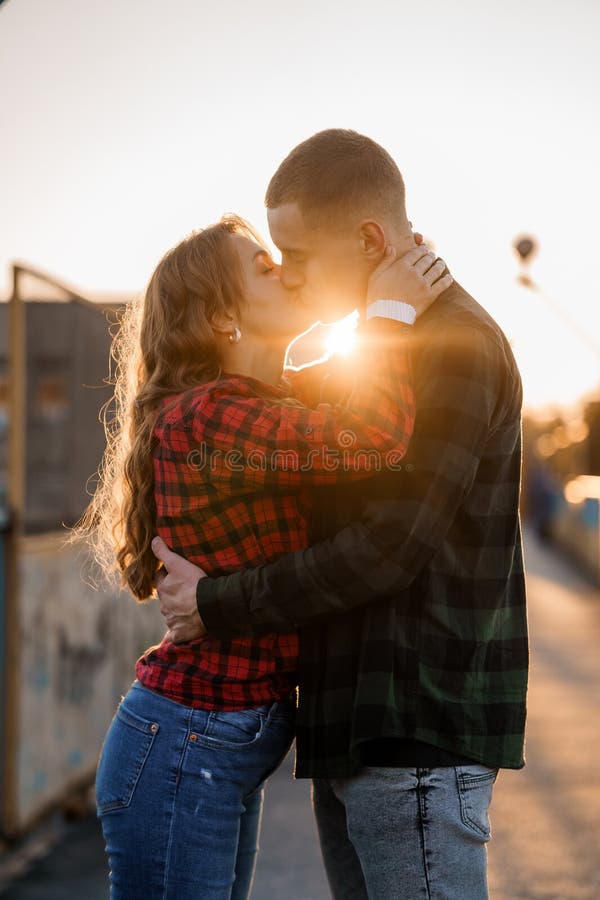 Couple Embracing in a Sunset Kiss with Warm Light Glowing Stock Photo ...