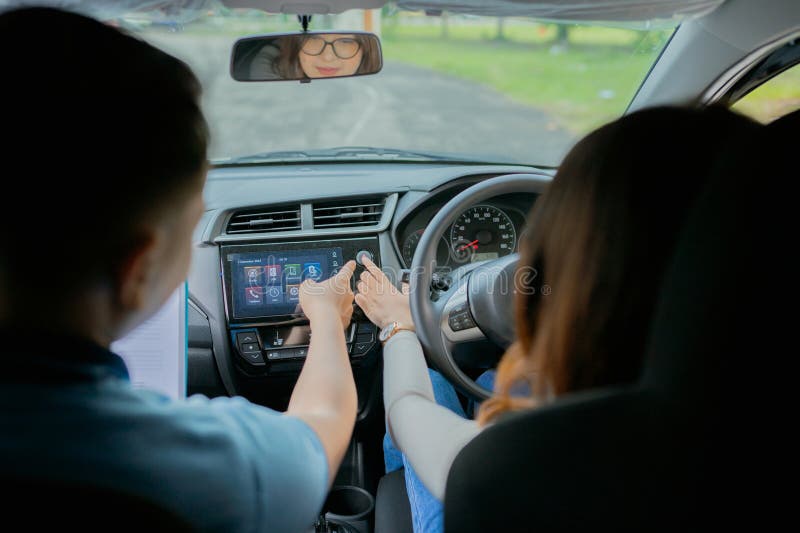 Couple Engaging with Modern Car Technology Together in an Interactive ...