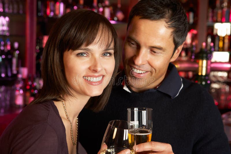 Couple Enjoying Drink Together in Bar Stock Photo - Image of couple ...