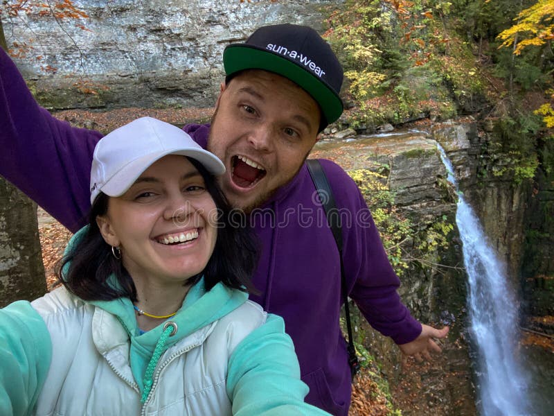 Couple Enjoying Nature by a Waterfall Stock Photo - Image of waterfall ...
