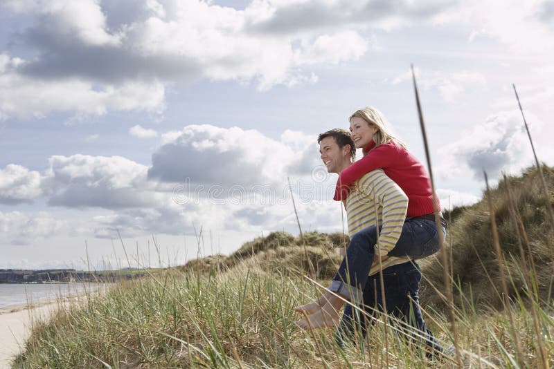 Couple Enjoying Piggyback Ride on Beach Stock Image - Image of couple ...