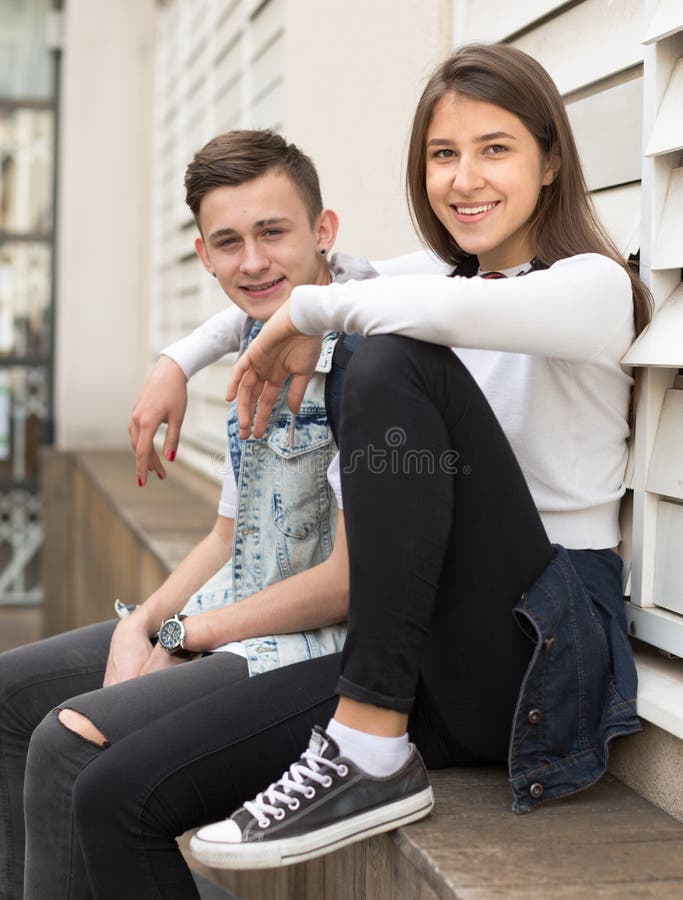 Modern Teenagers Chatting in the Yard and Holding Bikes Stock Photo ...